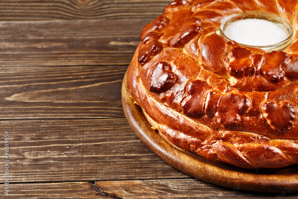 Russian wedding round loaf close-up on wooden table. Wedding bread with ...