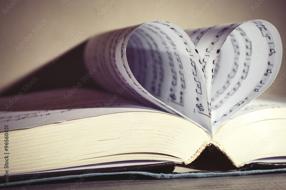 Book pages curved into heart shape on gray background Stock Photo ...