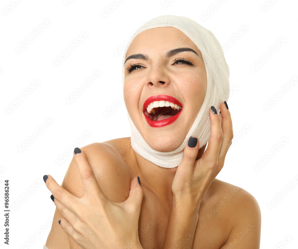 Young emotional woman with a gauze bandage on her head and chest ...