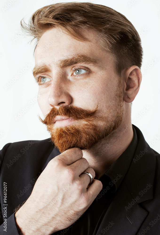 young red hair man with beard and mustache in black suit on white ...