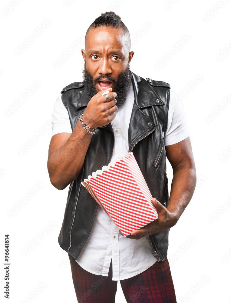 Foto de black man eating popcorn do Stock | Adobe Stock