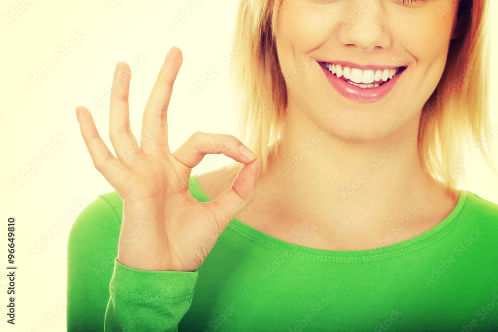 Young woman showing the perfect sign. Stock Photo | Adobe Stock