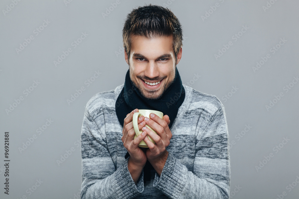 Young man holding cup of tea Stock Photo | Adobe Stock