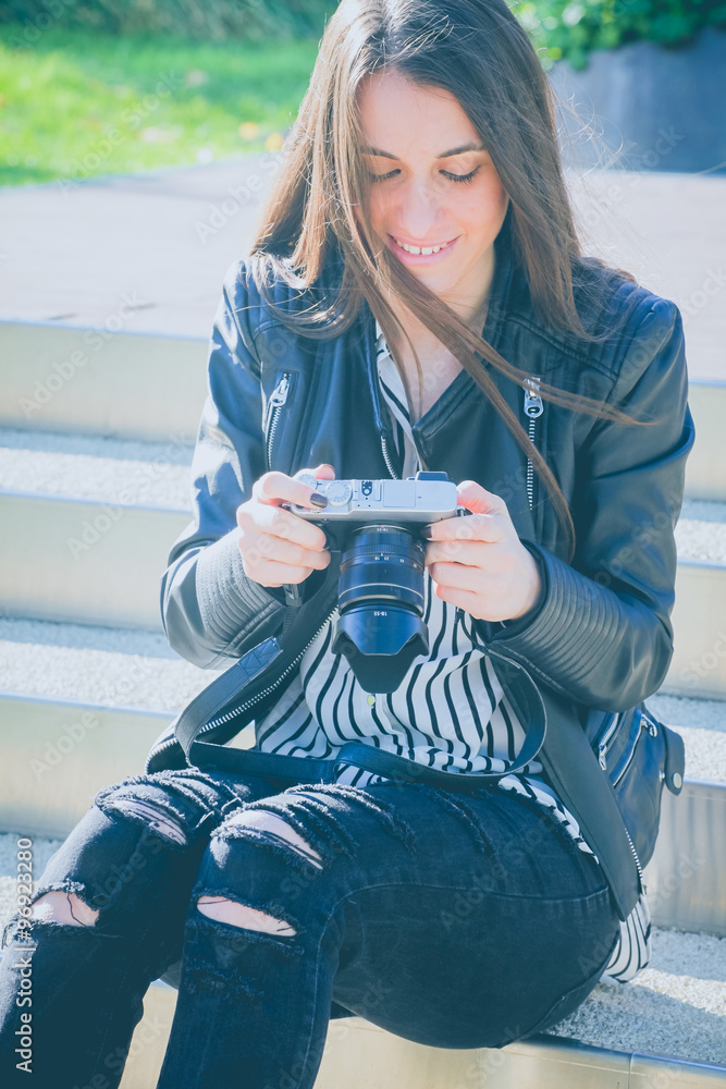Young beautiful woman watching photo on the camera Stock Photo | Adobe ...