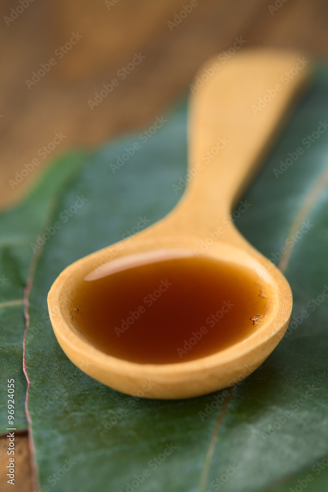 Eucalyptus cough syrup on wooden spoon on fresh Eucalyptus leaves (Very ...