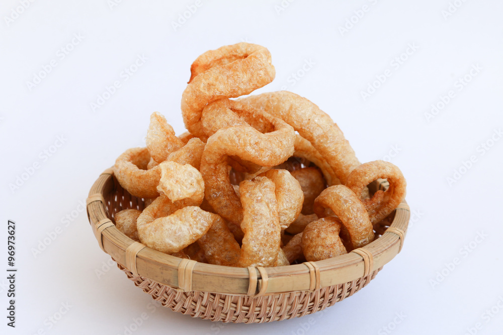 Crispy Pork Skin , Thai style food in a wicker basket isolated over the ...