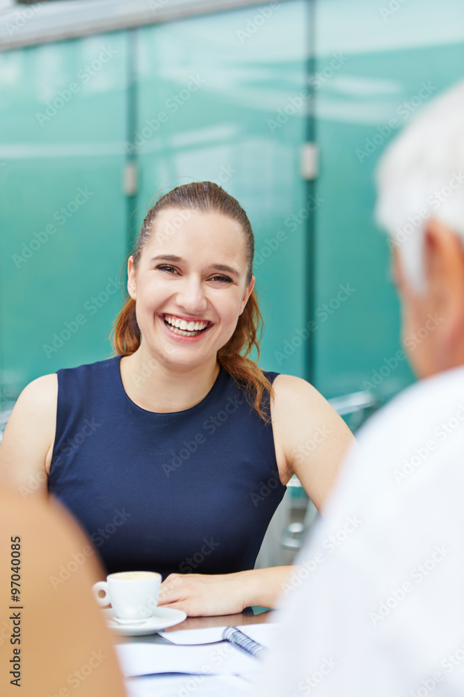 Smiling woman drinking coffee in a café Stock Photo | Adobe Stock