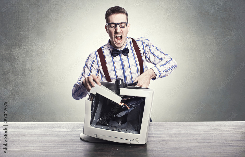 young angry nerd destroying old computer monitor Stock Photo | Adobe Stock