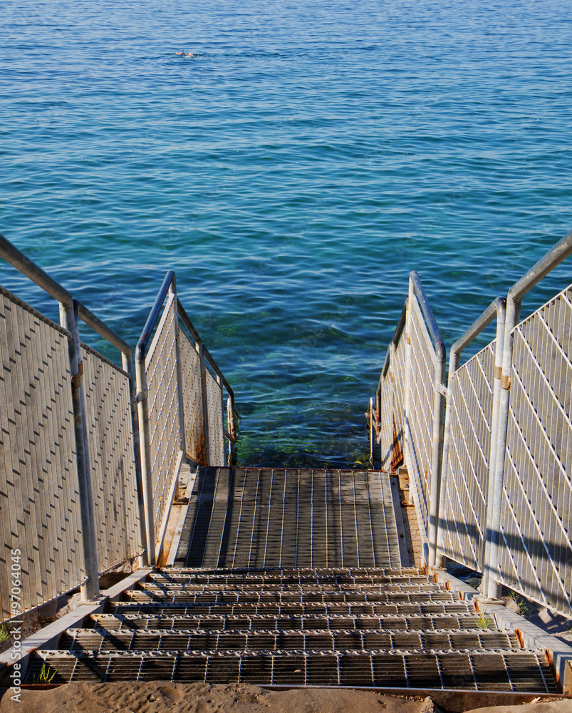 steps to the transparent Adriatic sea waters on the free strand of ...