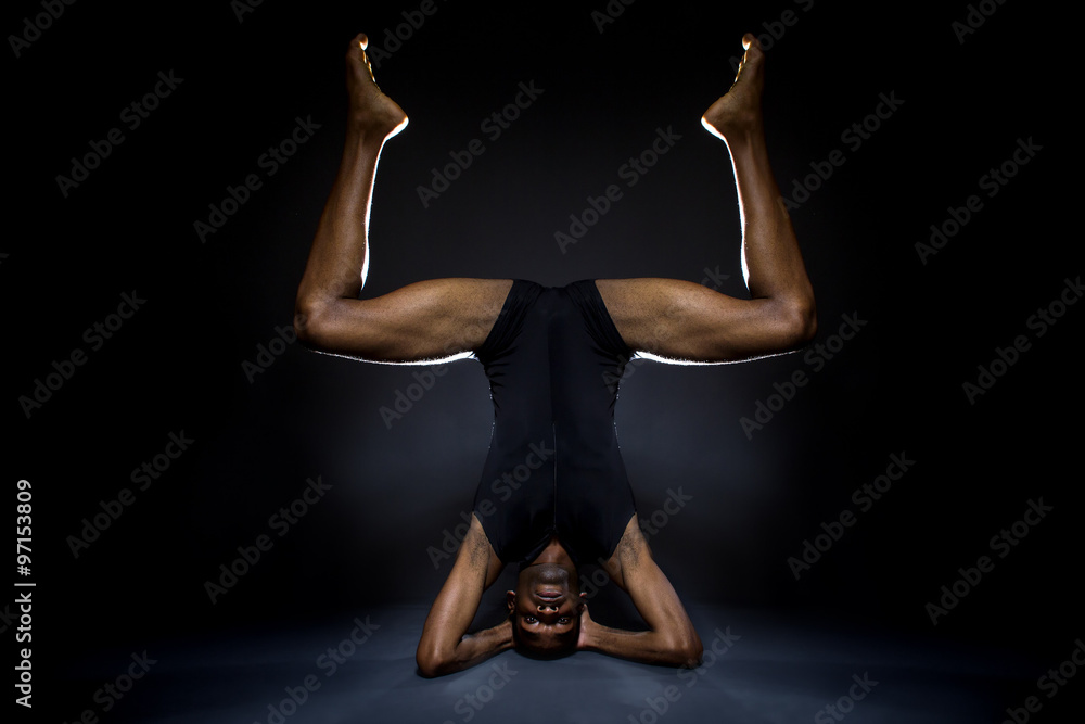 Black male dancer practicing warm up exercises for flexibility Stock ...