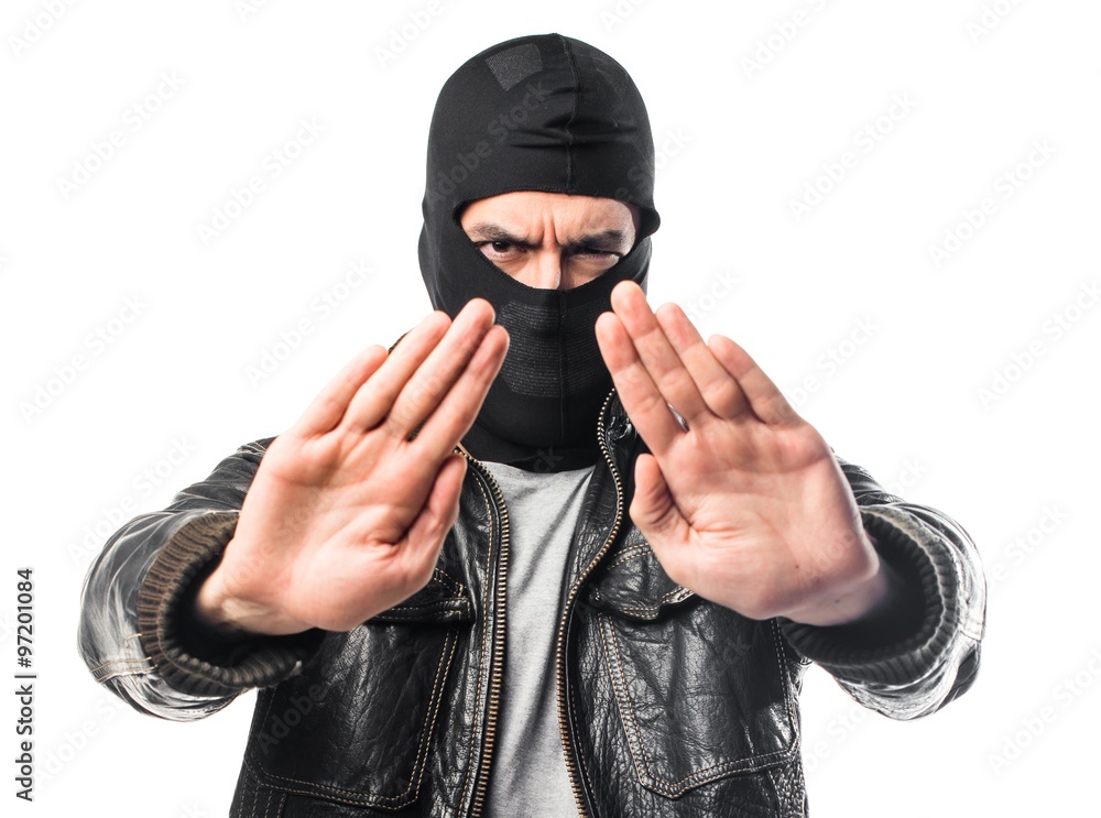 Foto Stock Robber making stop sign | Adobe Stock