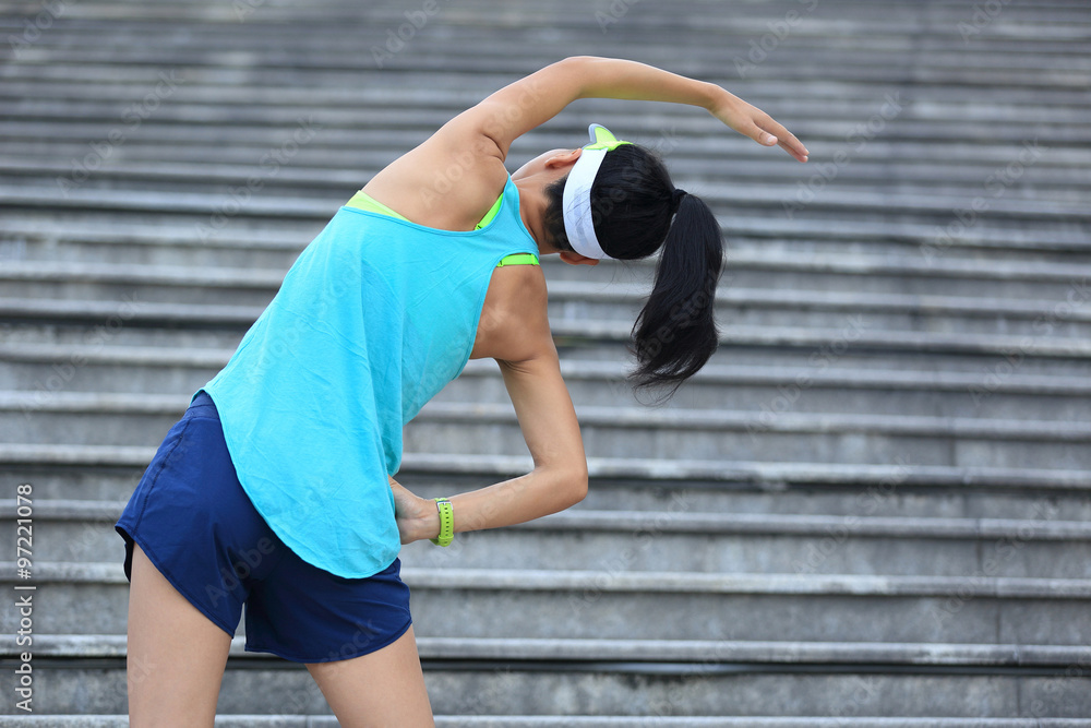 young fitness woman runner stretching arms before run Stock Photo ...