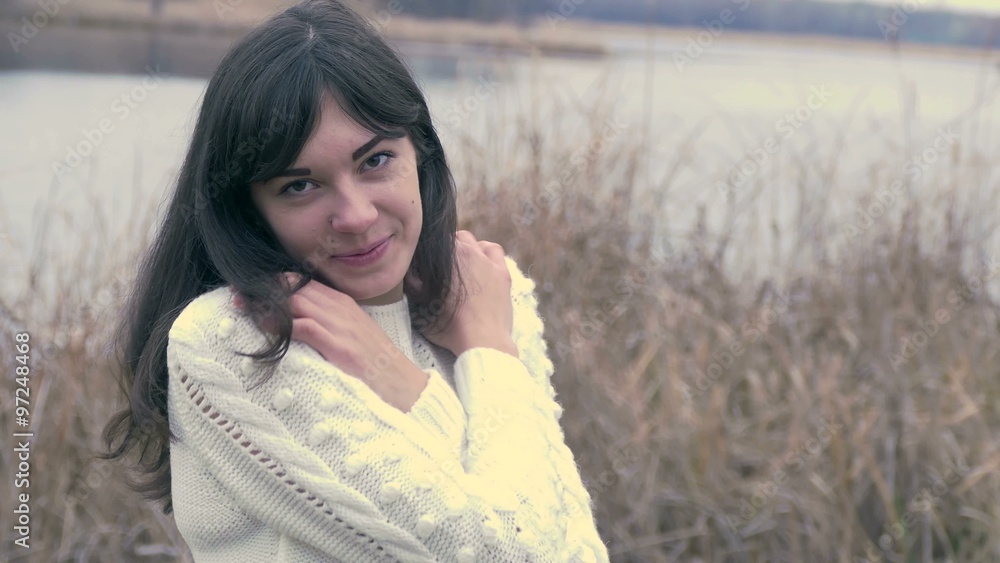 girl woman cold rubs his hands in white jacket from dry grass Stock ...