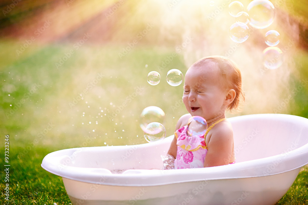 beautiful little girl in the summer bathing with soap bubbles Stock ...