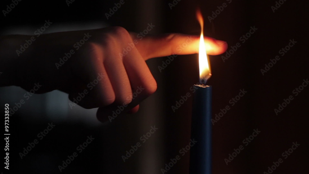 playing with fire, passing finger through candle flame Stock Video ...