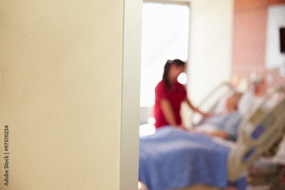 Focus On Hospital Room Sign With Nurse Talking To Patient Stock Photo ...