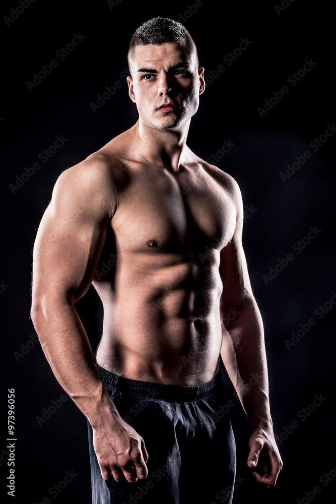 beautiful male athlete shirtless isolated over black background Stock ...