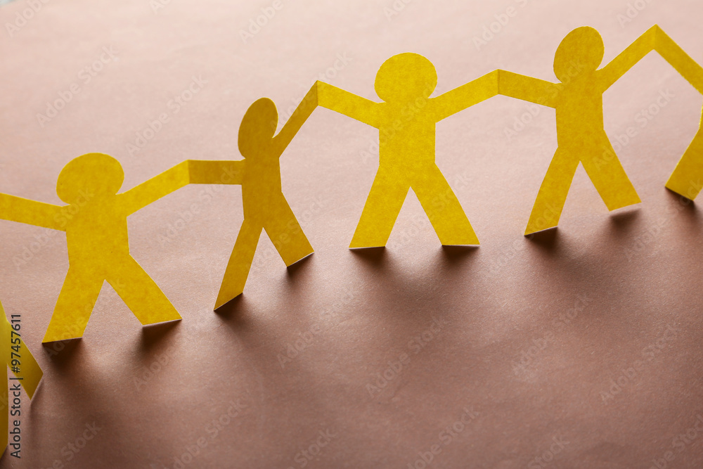 Paper people on the brown paper background Stock Photo | Adobe Stock