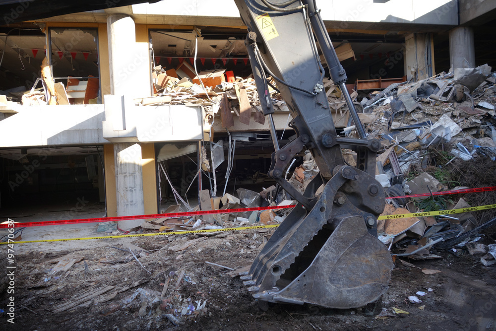 building destroyed by disaster with heavy equipment for clean up Stock ...