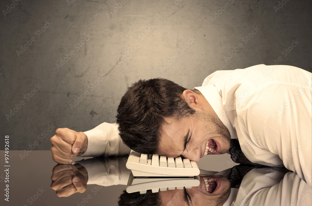 Frustrated businessman's head on keyboard Stock Photo | Adobe Stock