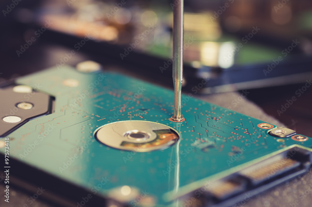 Screwdriver unscrews the screw hard disk Stock Photo | Adobe Stock