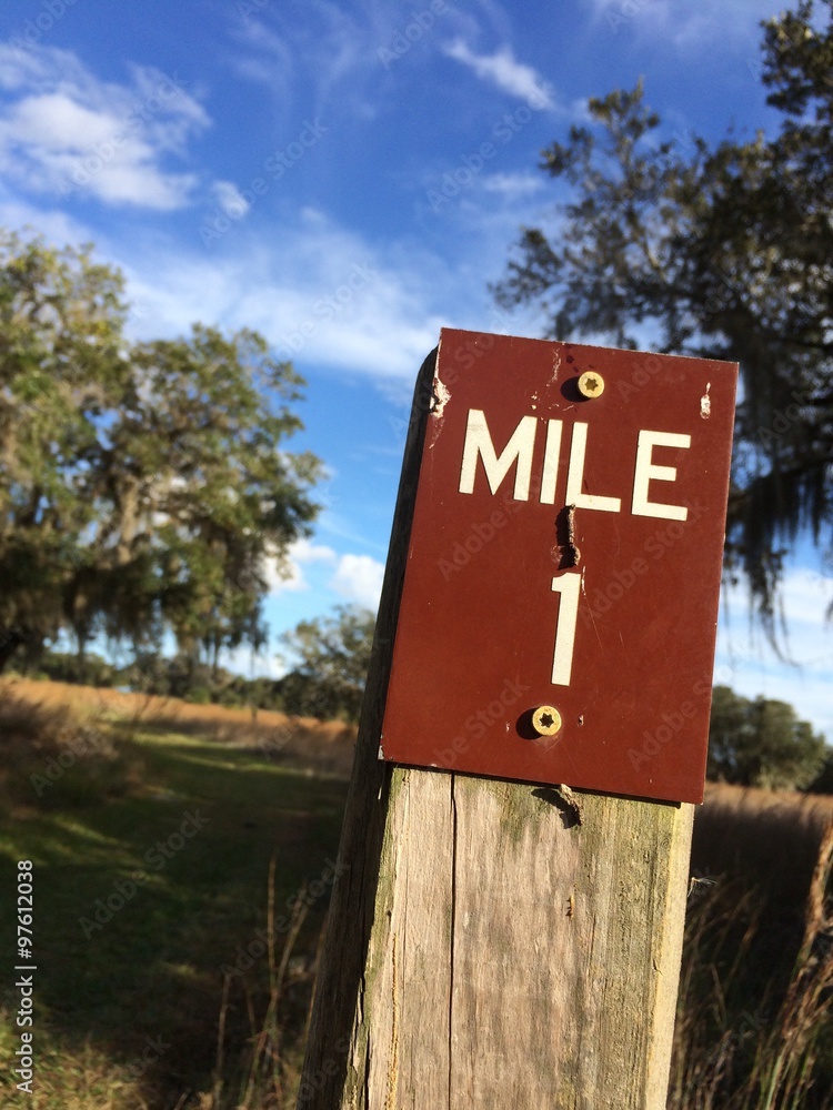 1 mile marker at a hiking trail Stock Photo | Adobe Stock