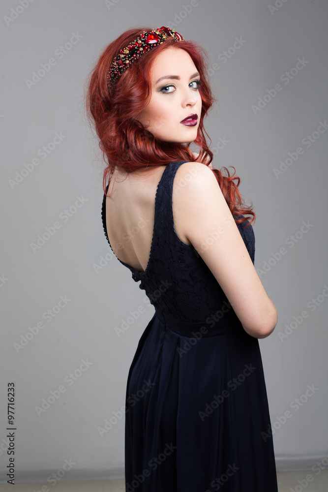 Beautiful red-haired fashion model posing in evening dress and in the ...