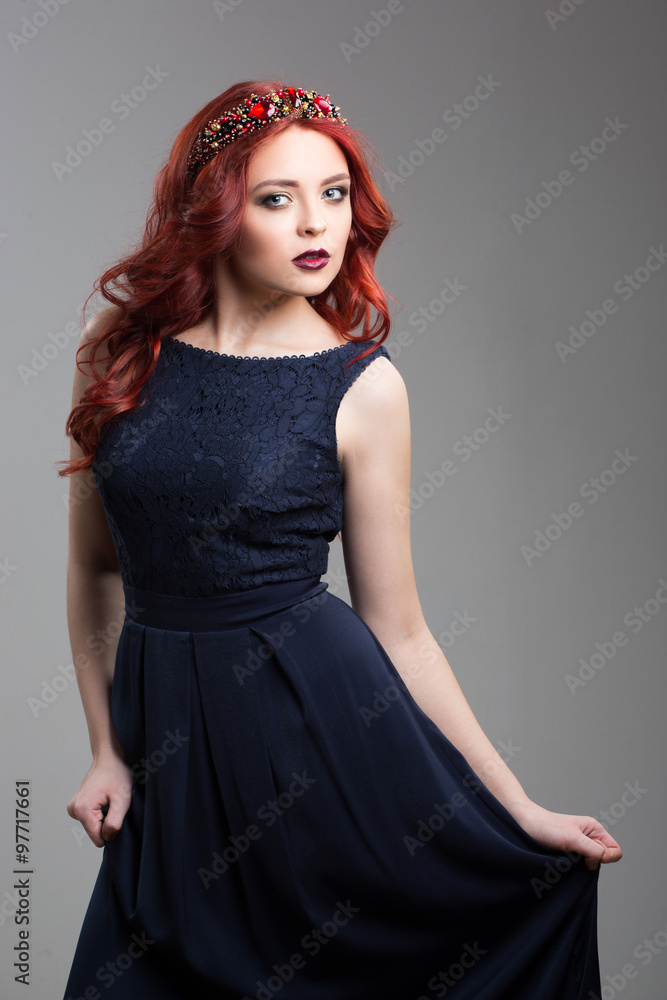 Beautiful red-haired fashion model posing in evening dress and in the ...