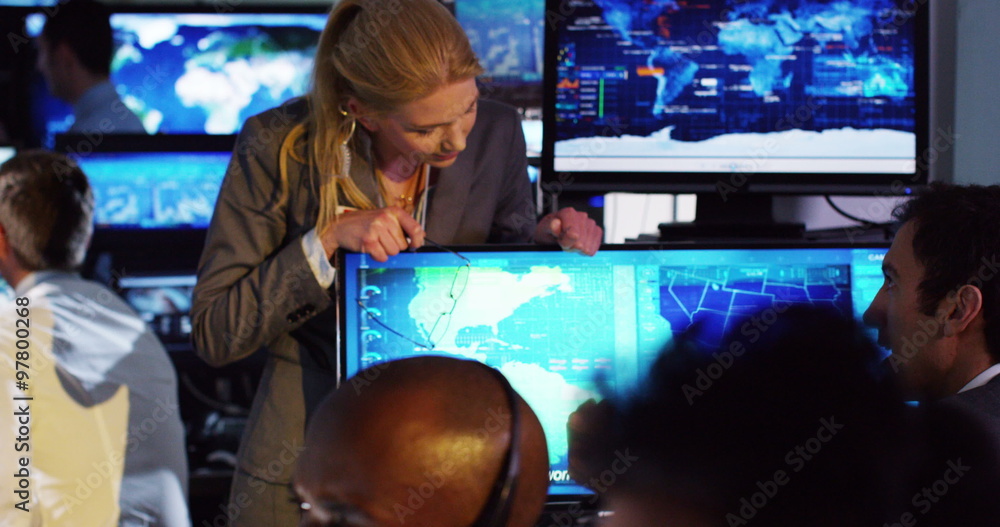 Security & surveillance team working in a busy system control room ...