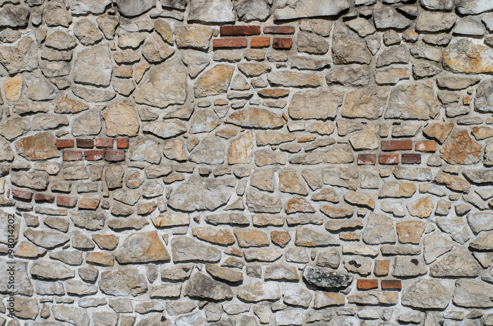 Foto de Part of castle wall made of limestone bricks built on white ...