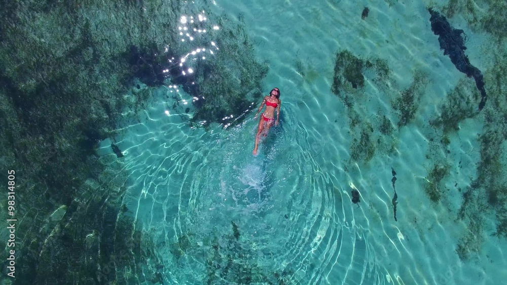 Young and beautiful fashion female model in red bikini lying on the ...