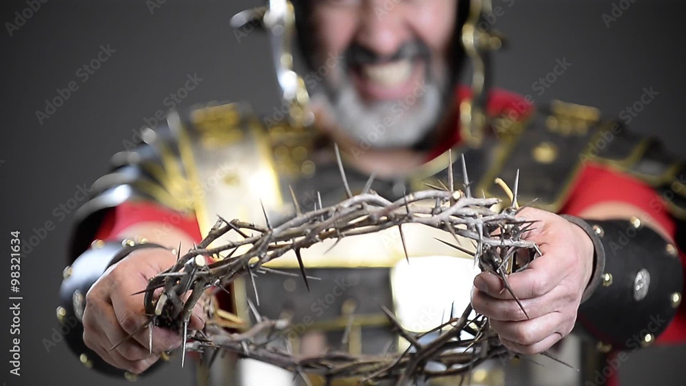 Roman soldier soldier crown of thorns with sword while laughing Stock ...