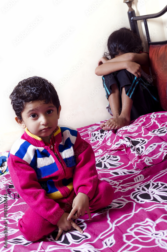 sad siblings boy girl sitting Stock Photo | Adobe Stock