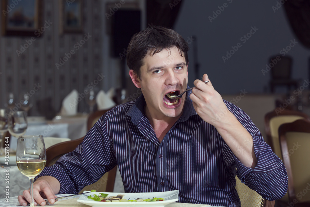 young man having dinner in a restaurant Stock Photo | Adobe Stock