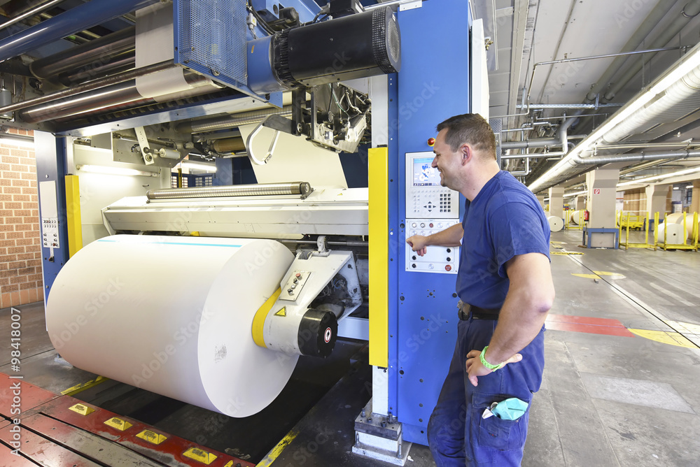 Man operating printing machine in a printing shop Stock-Foto | Adobe Stock