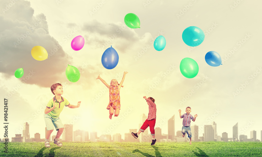 Playful children catch balloons Stock-Foto | Adobe Stock