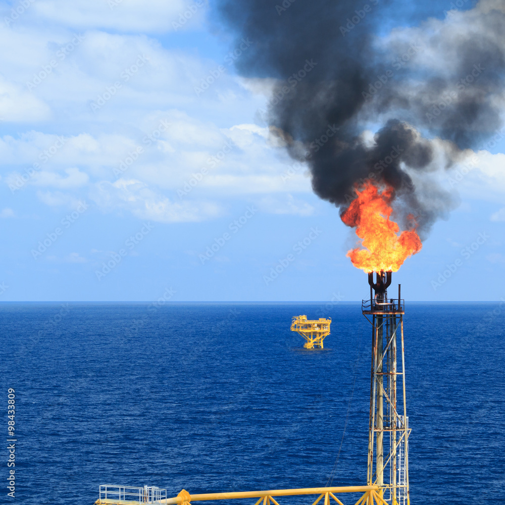Hot flare boom and fire on offshore production platform Stock Photo ...