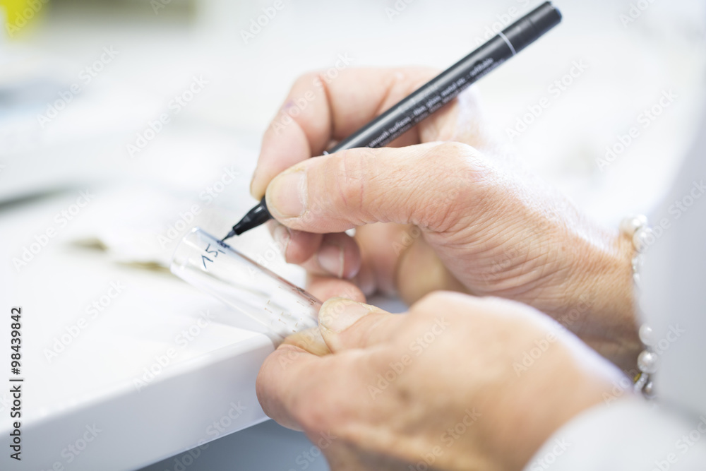 Hands of female scientist labelling test tube in a laboratory Stock ...