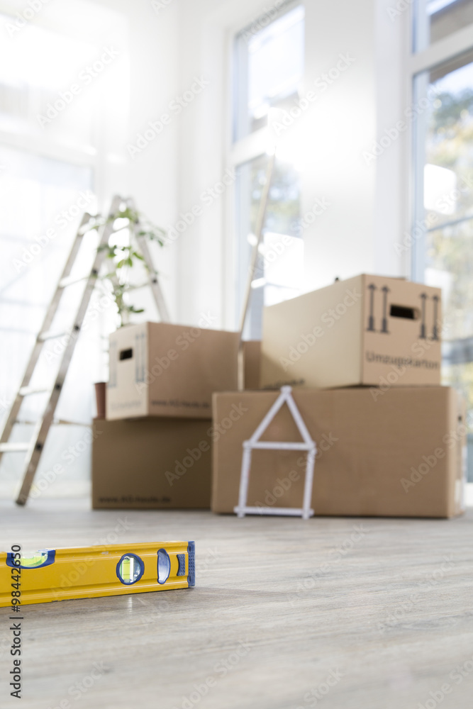 Cardboard boxes and water level in new home Stock Photo | Adobe Stock