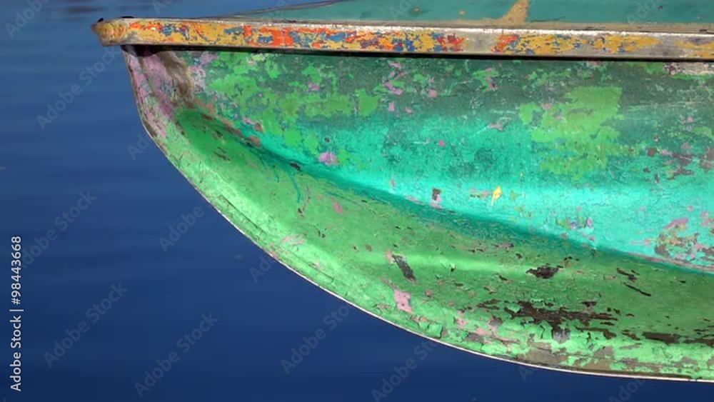 Vivid background of an old cracked boat with sun flecks reflection on ...