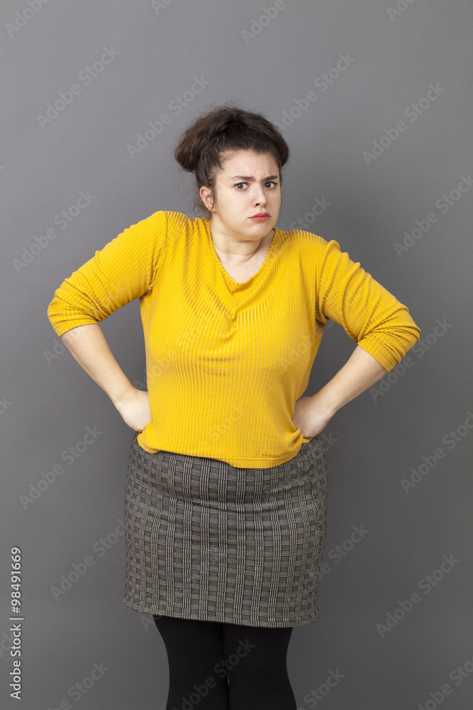 pride and arrogance - offended big young woman standing with hands on ...