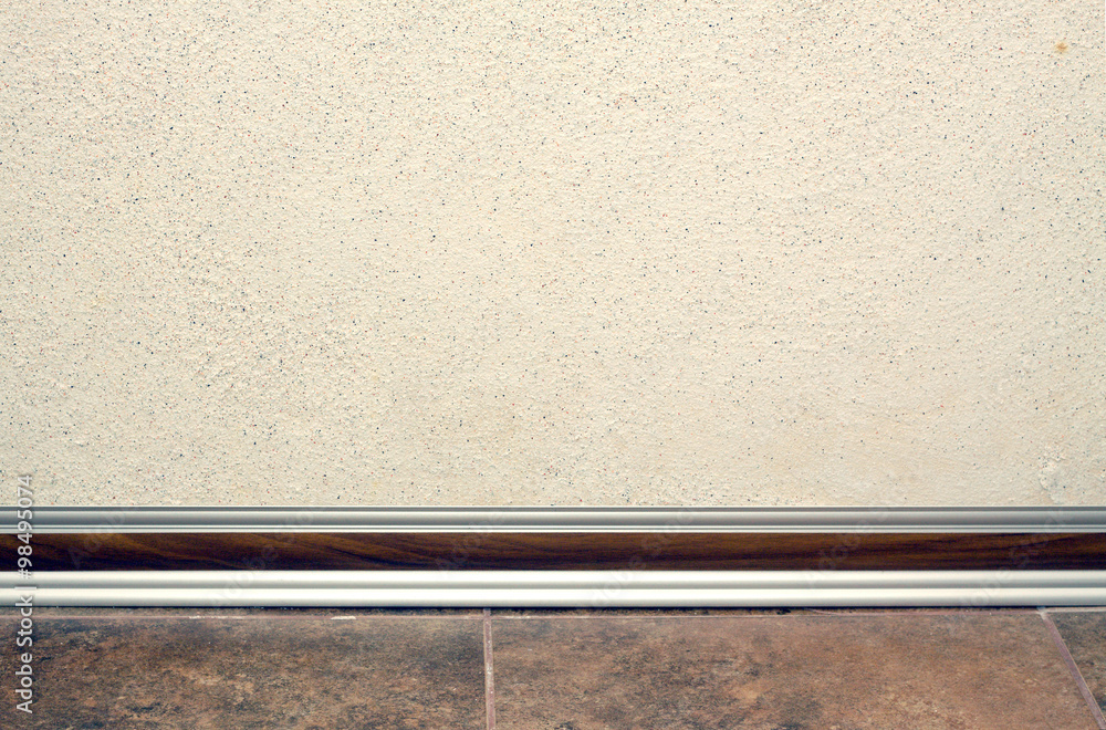 Part of the wall with baseboard after renovation, covered with ...