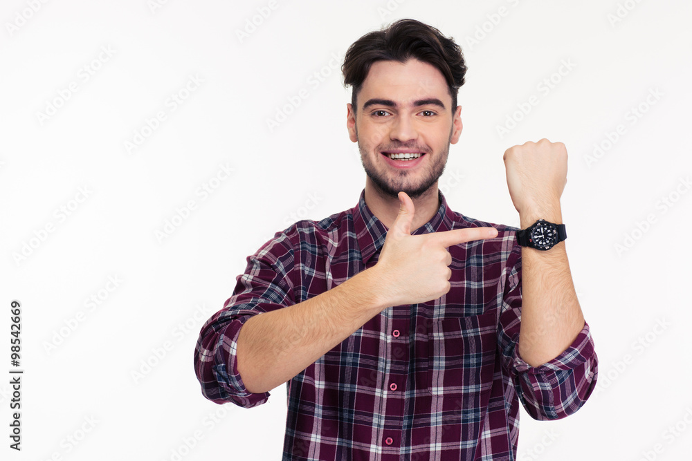 Smiling man pointing finger on wrist watch Stock Photo | Adobe Stock