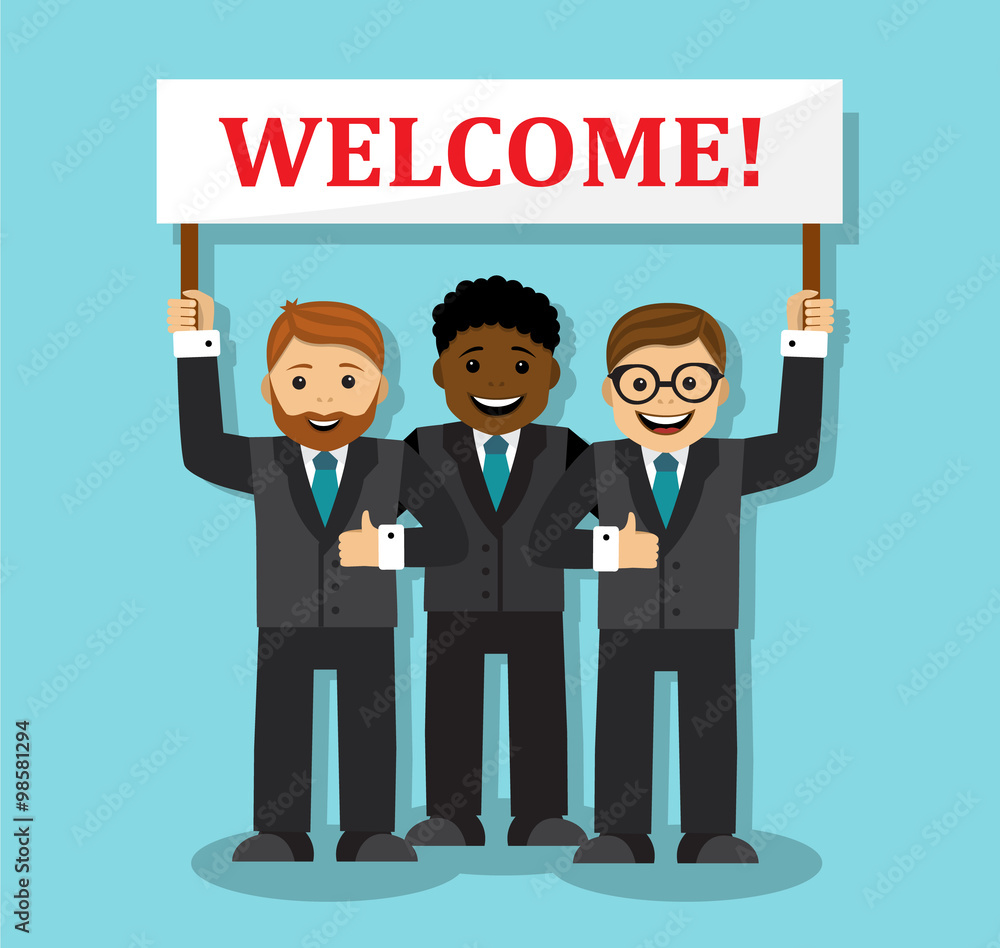 three businessmen of various nations are holding a sign saying welcome ...