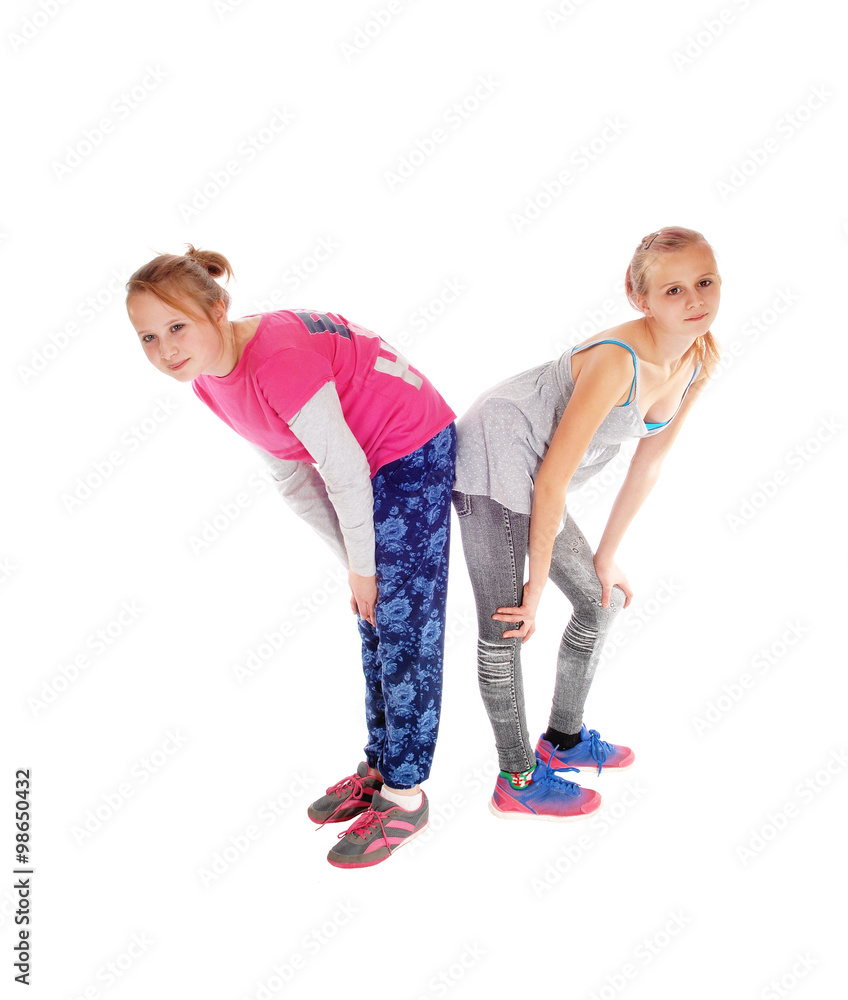 Two sisters standing butt on butt. Stock Photo | Adobe Stock