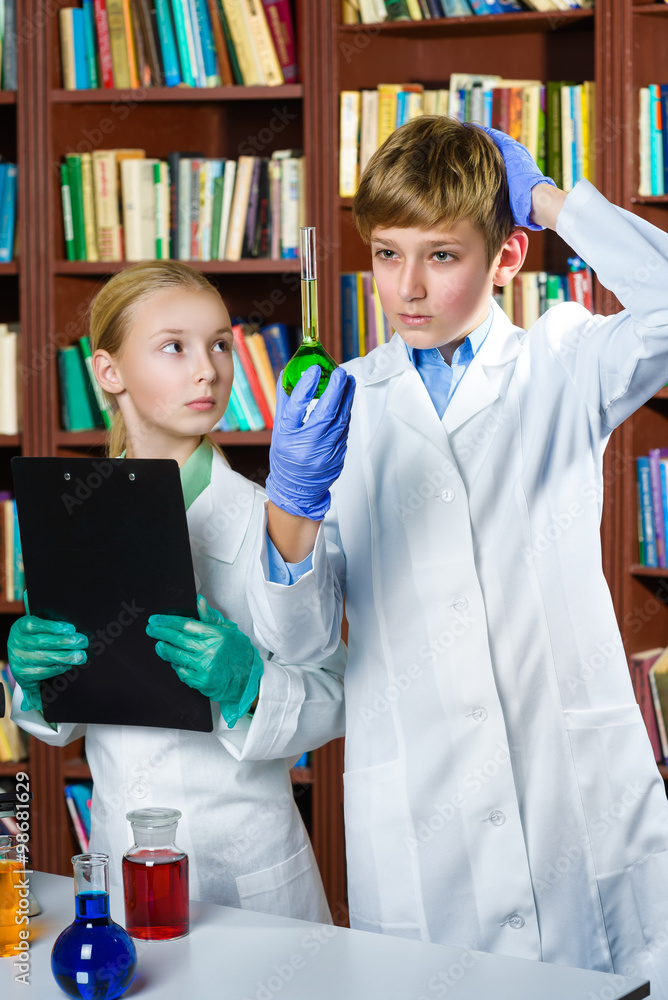 Cute boy and girl doing biochemistry research in chemistry class Stock ...