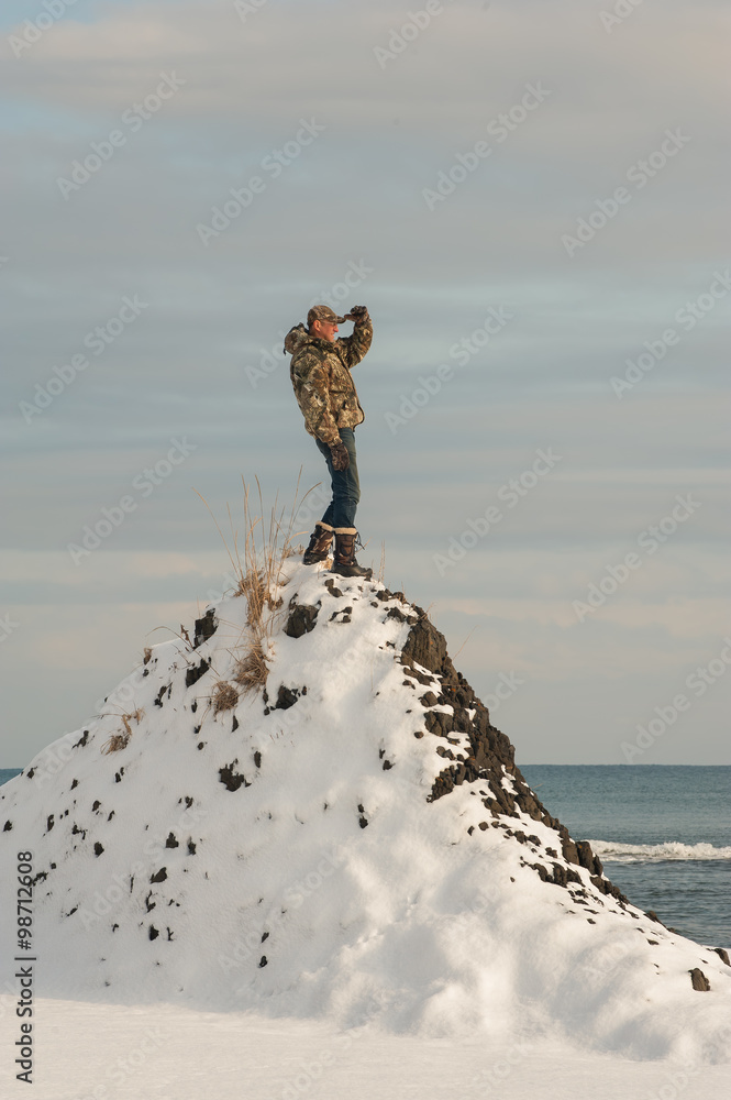 Observation/Photo of a tourist standing on the cliff, watching the ...