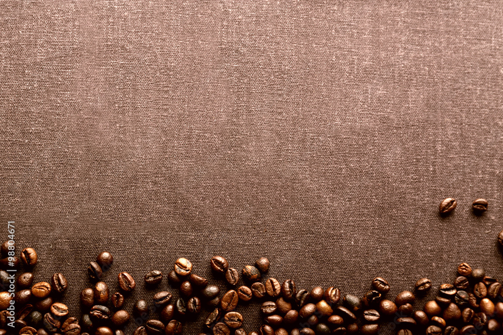 Roasted coffee beans on grey textile background Stock Photo | Adobe Stock