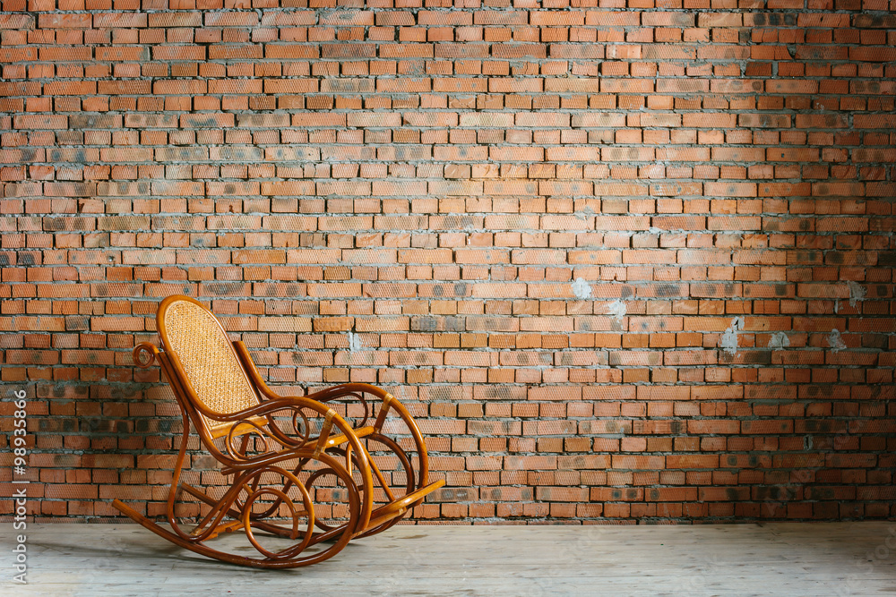 Wooden rocking chair against old brick wall background interior Stock ...