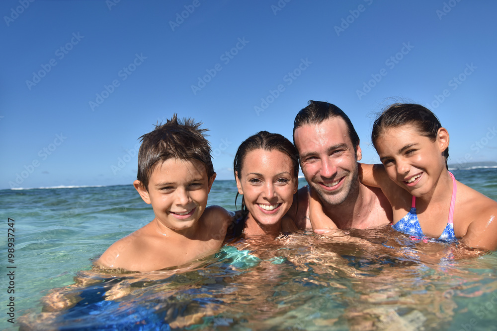 Happy family enjoying swimming in caribbean sea 스톡 사진 | Adobe Stock
